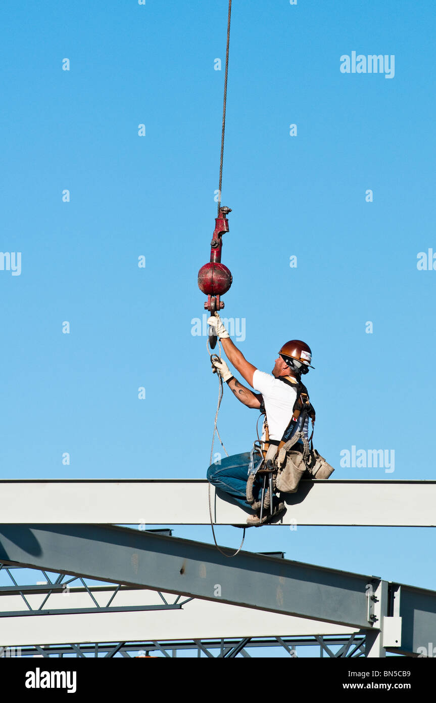 steelworkers erect the structural steel framework for a commercial ...