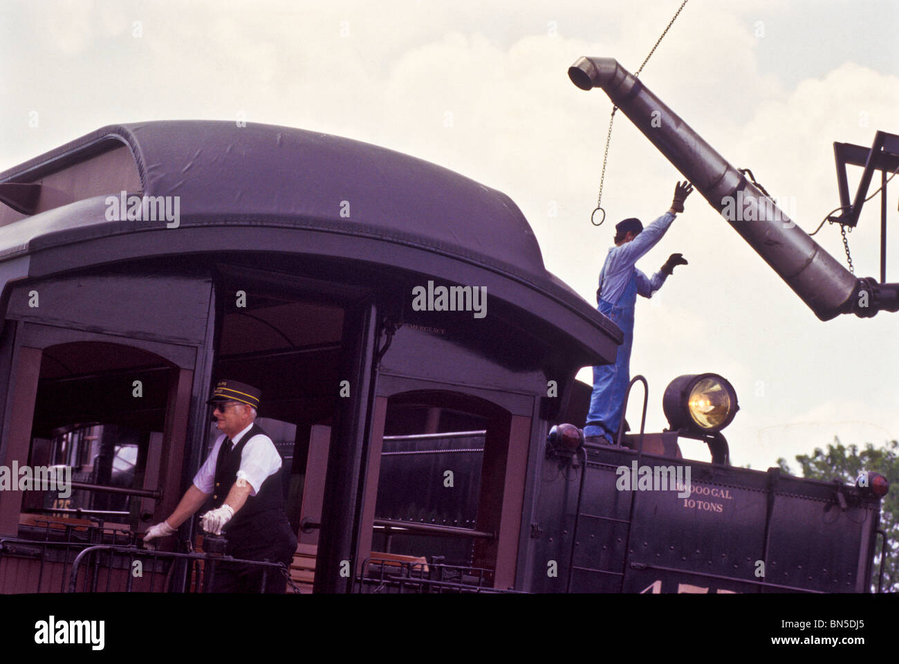 Conductor engineer fireman connect to water tower Stock Photo - Alamy