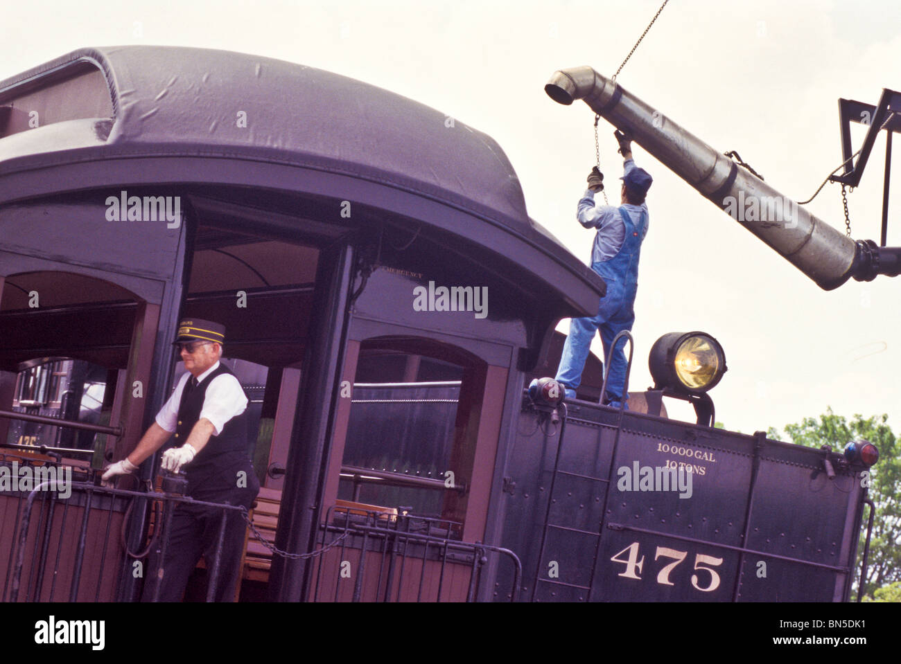 Conductor engineer fireman connect to water tower Stock Photo - Alamy