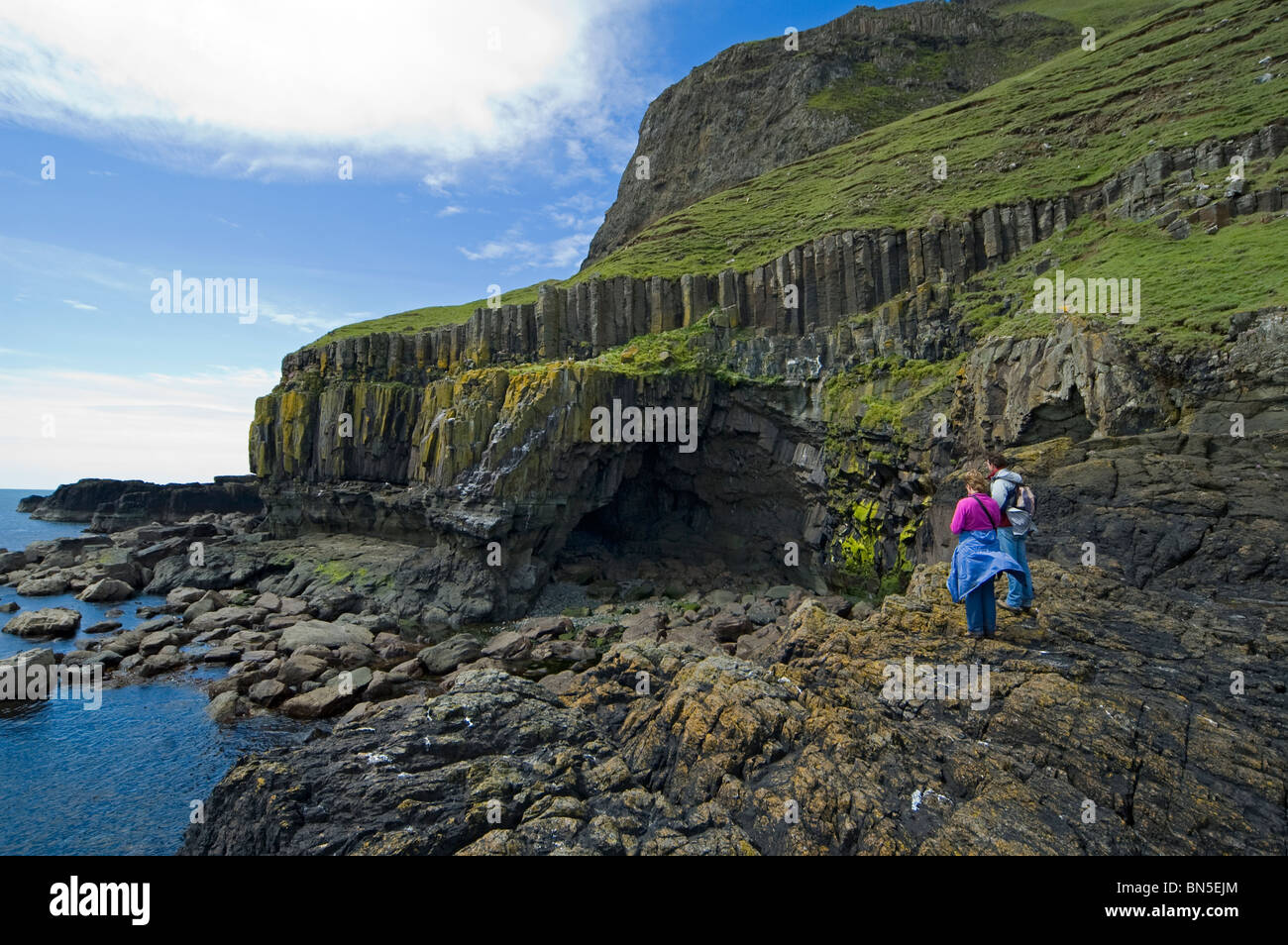 Walkers at one of the Carsaig Arches, Isle of Mull, Inner Hebrides ...