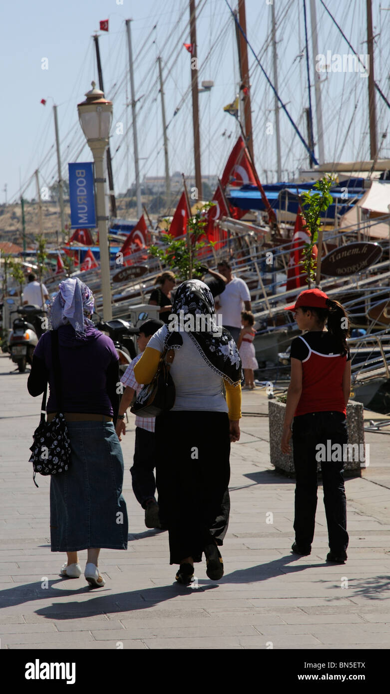 Turkish adult women and a child walk with their heads covered as is the ...
