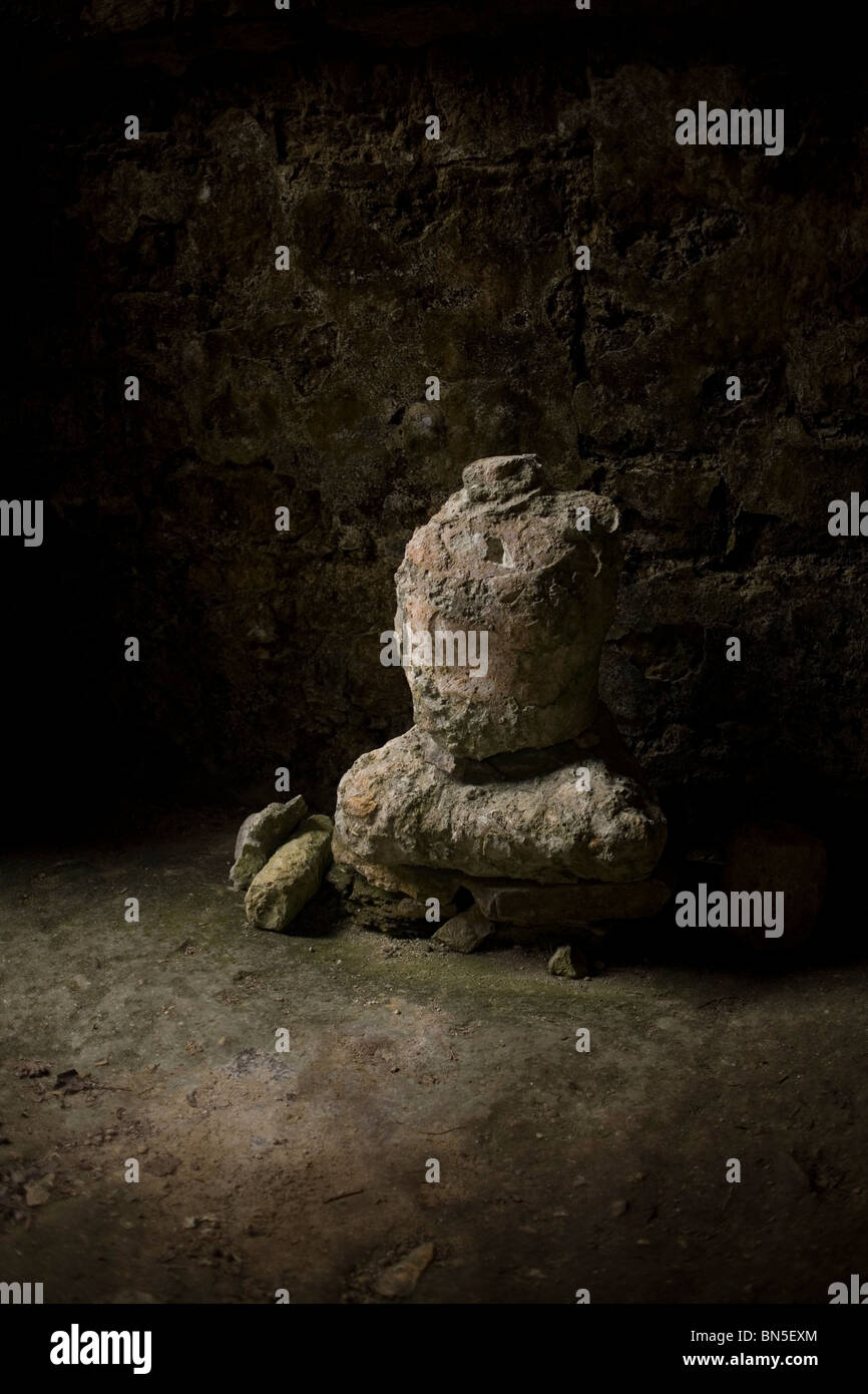 A Mayan God sculpture in lotus position on a building at the ancient ...