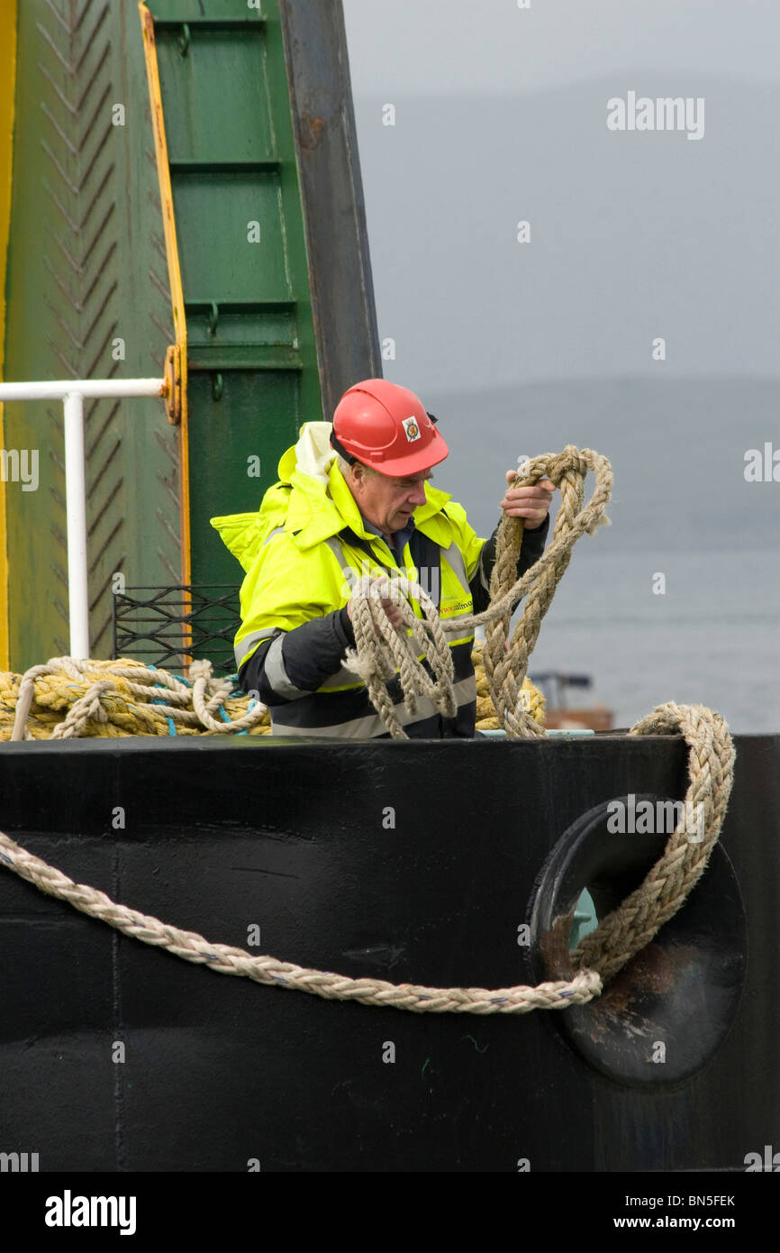 Sailor handling hawser Caledonian McBrayne ferry at Oban Argyll ...