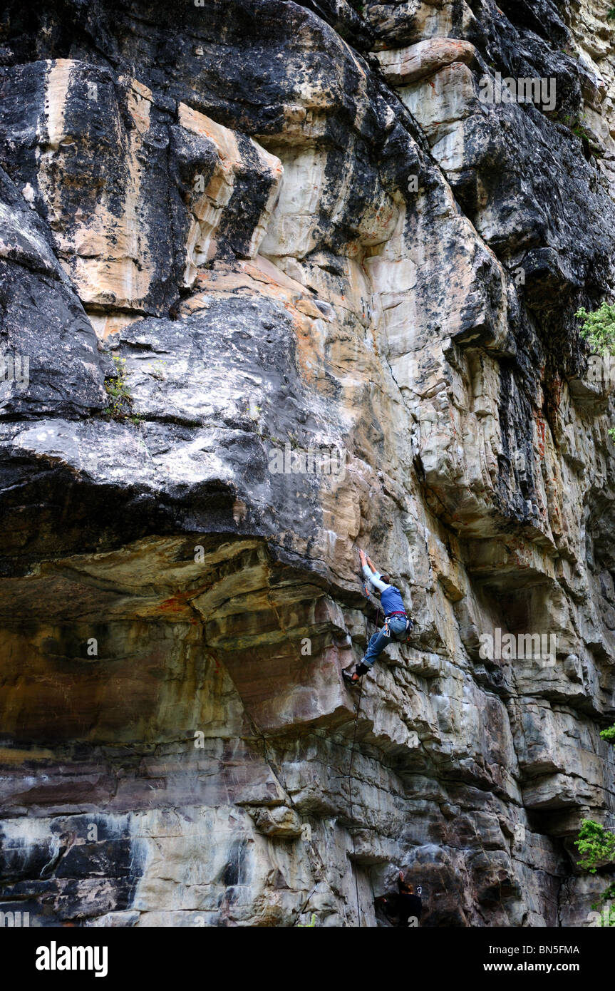 A rock climber maneuvering rocky cliff. Banff National Park, Alberta ...