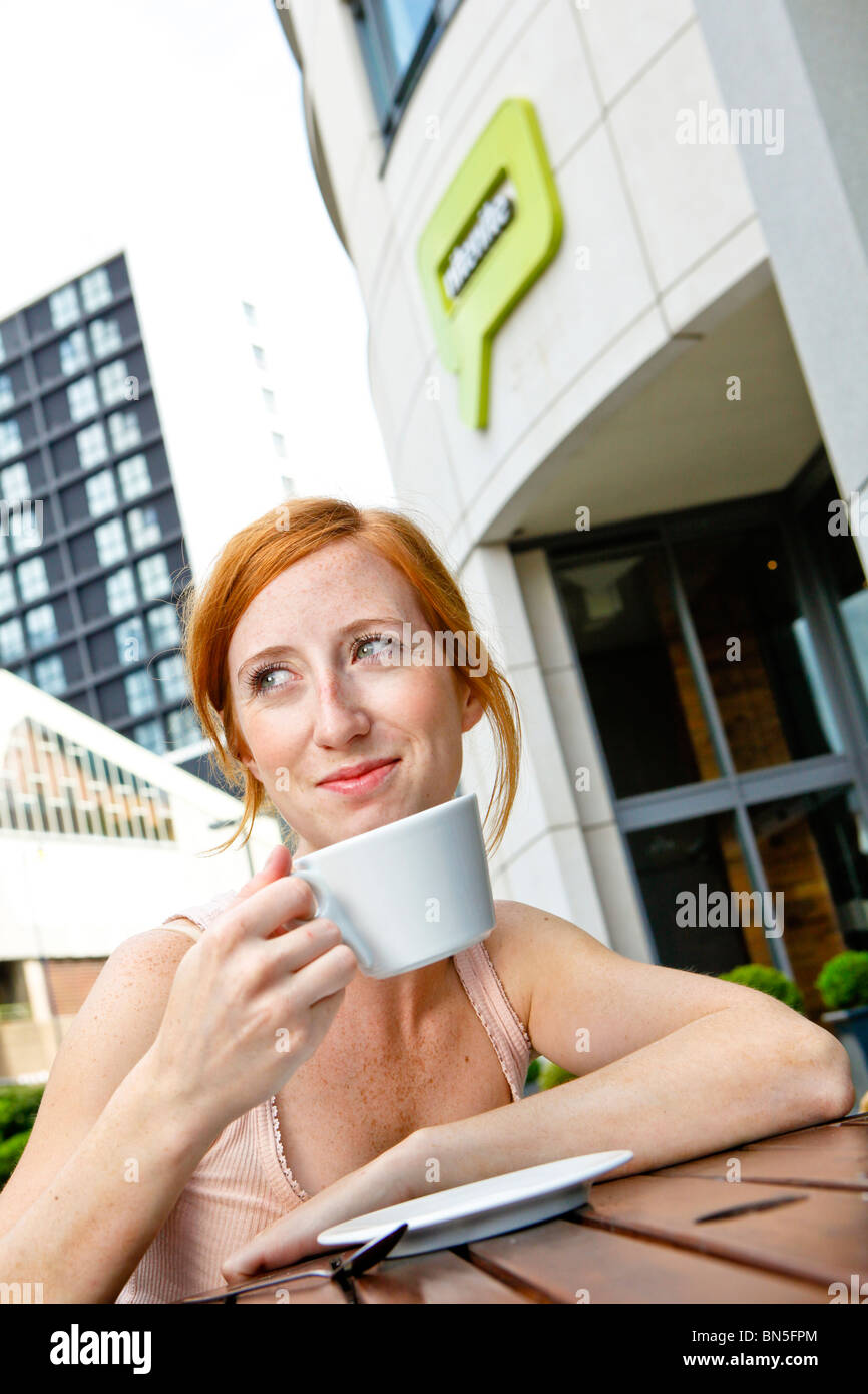 Woman drinking coffee in coffee shop Stock Photo - Alamy