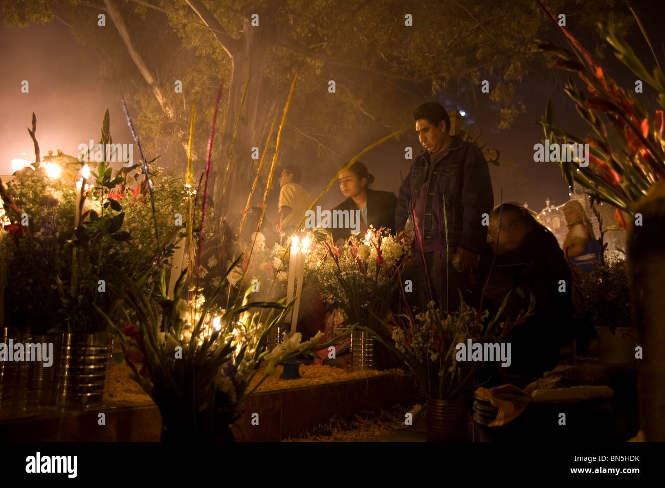 Persons decorating the tomb of their deceased familiy members on the ...