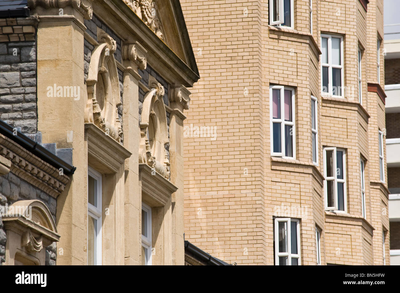 Modern apartment building juxtaposed with period Victorian building on ...