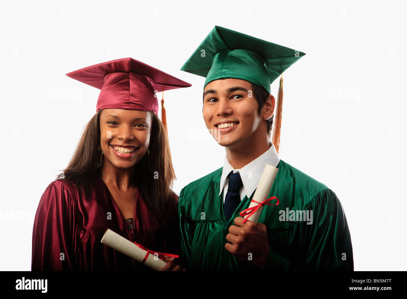 multi racial couple in cap and gown with diploma at graduation Stock ...