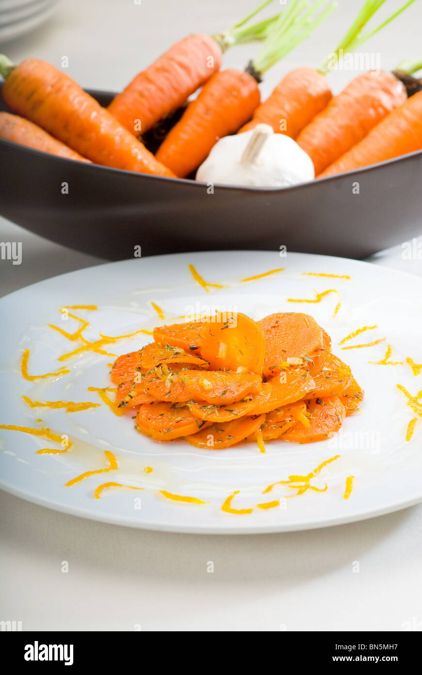 fresh and healthy Honey glazed carrots on a plate with tyme on top ...