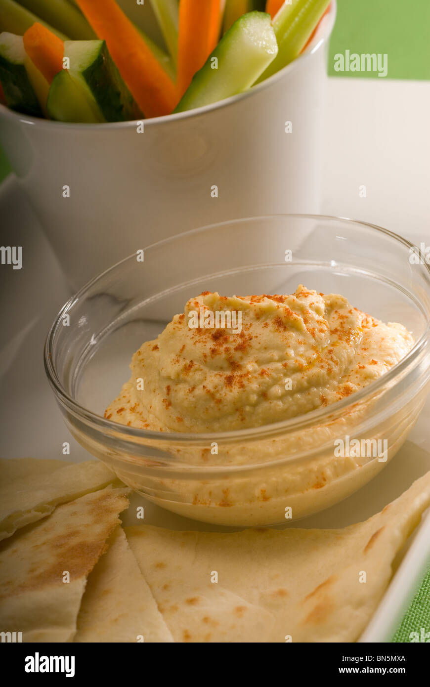 middle eastern hummus dip on a glass bowl with homemade pita bread and ...