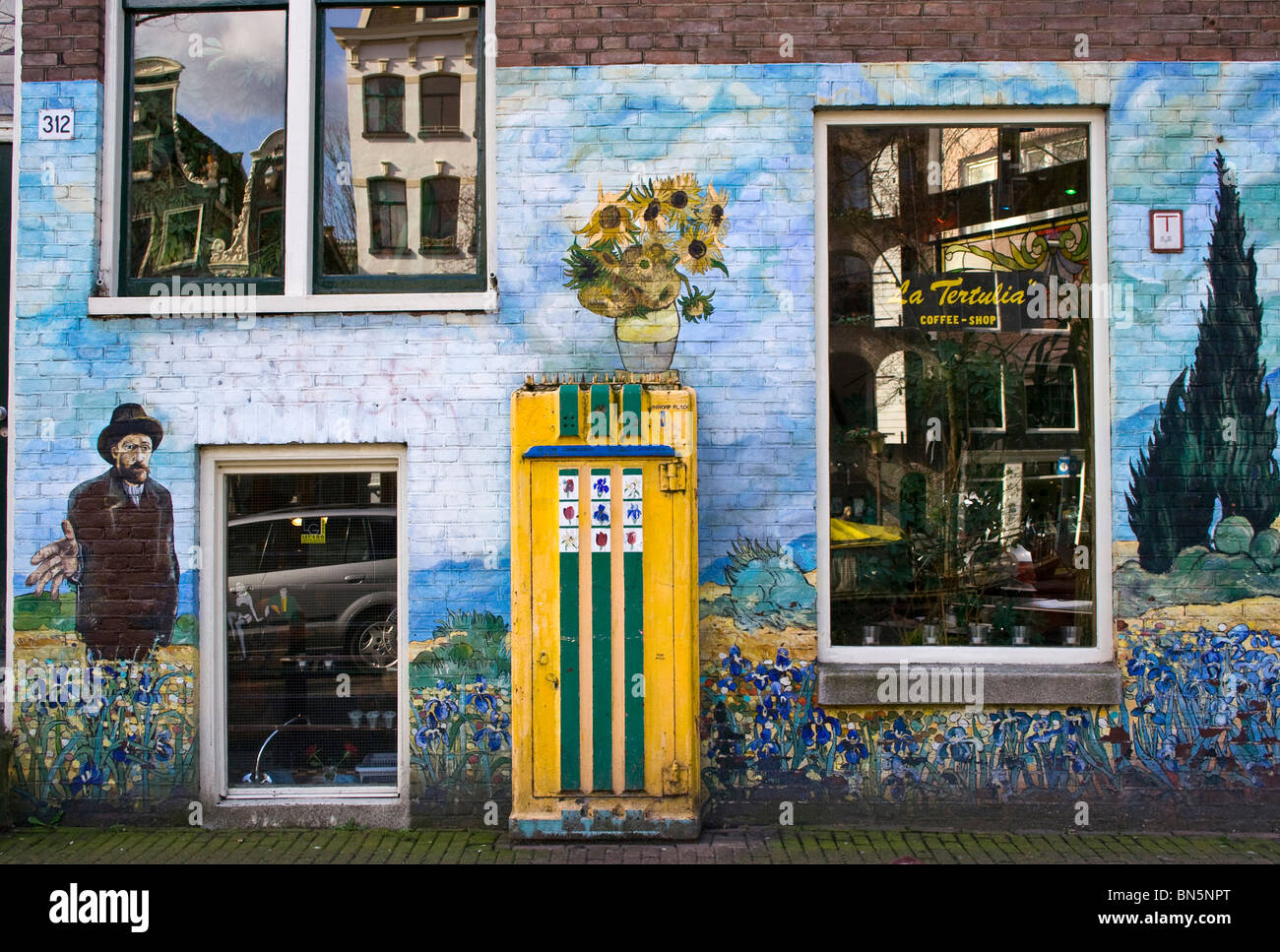 The exterior of a Coffee House in Amsterdam with murals and window ...