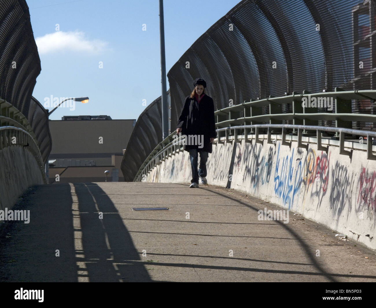 Lonely woman walking over bridge hi-res stock photography and images ...