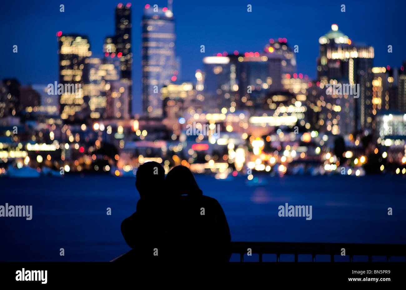A Silhouetted Couple with a Nighttime Downtown Seattle Skyline Backdrop ...