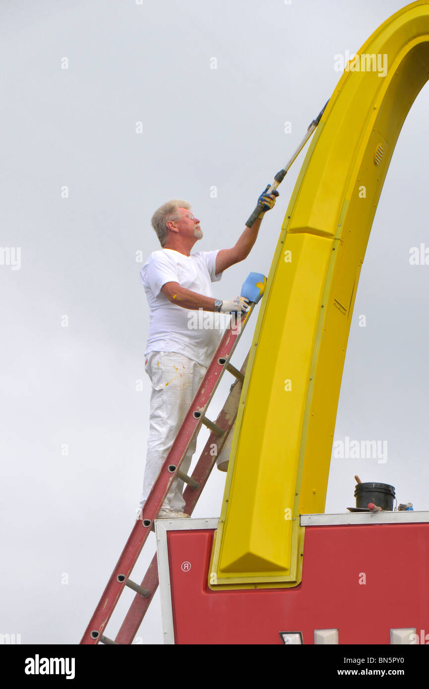 Restoration painting repair on commercial sign Stock Photo - Alamy