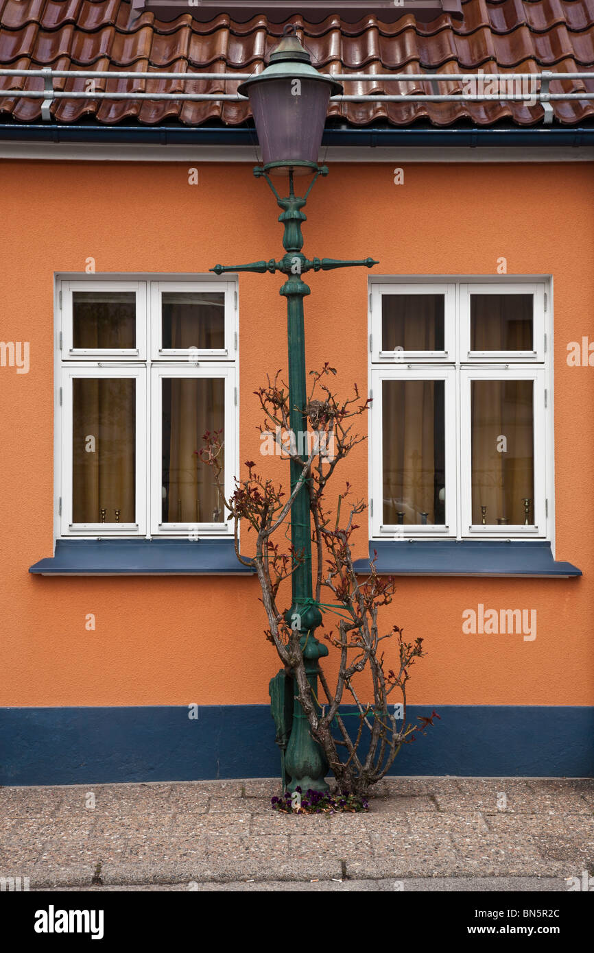 Facade of an orange house with street lamp Stock Photo - Alamy