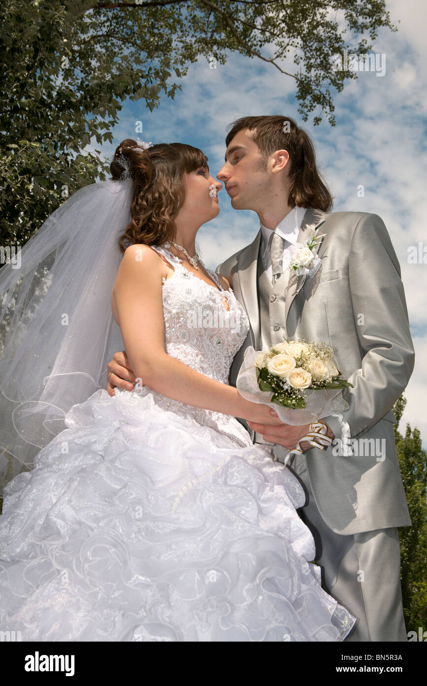 Groom and the bride embrace on a background of the dark blue sky Stock ...