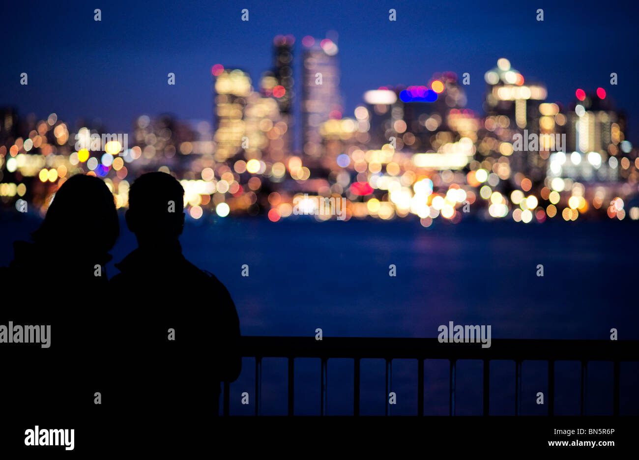 A Silhouetted Couple with a Nighttime Downtown Seattle Skyline Backdrop ...