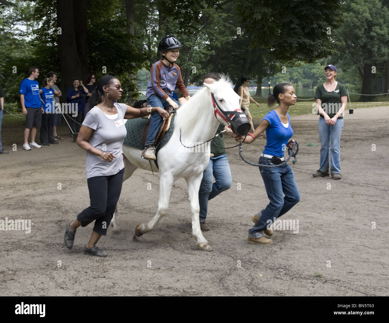 Disabled children receive developmental therapy learning to ride horses ...