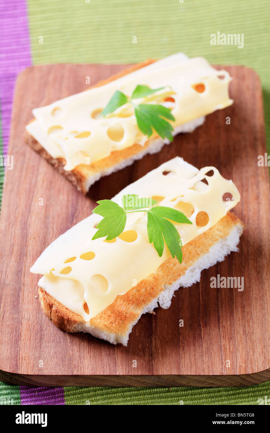 Slices of Swiss cheese on toasted bread Stock Photo - Alamy