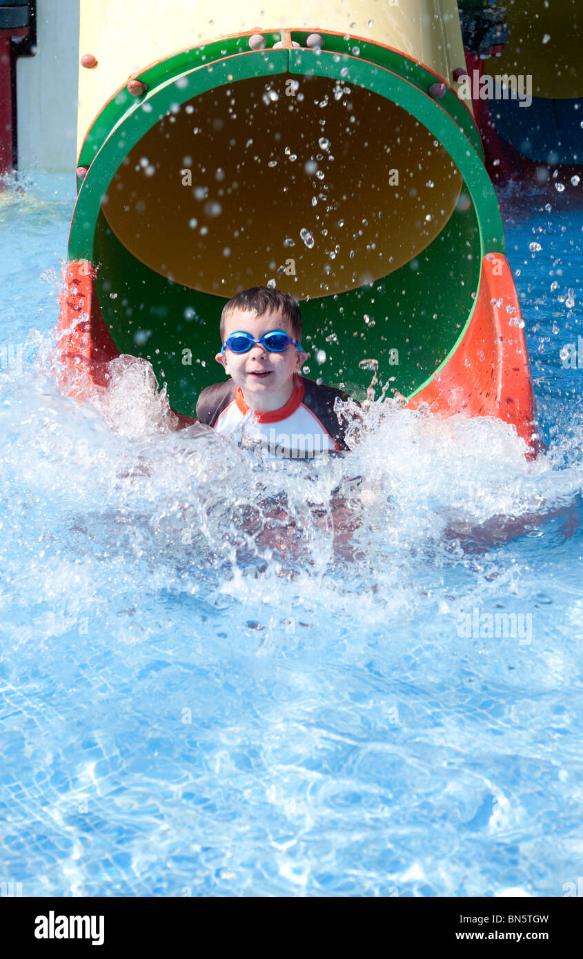 A young boy shoots down a water tube into a pool at a Hydro Park in ...