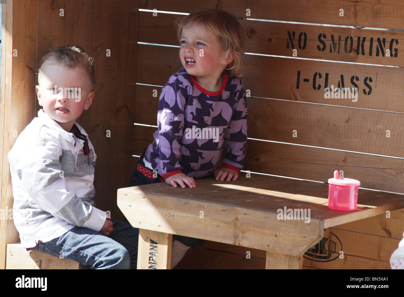 Toddlers siblings boy girl play playing together sat sitting at a table ...
