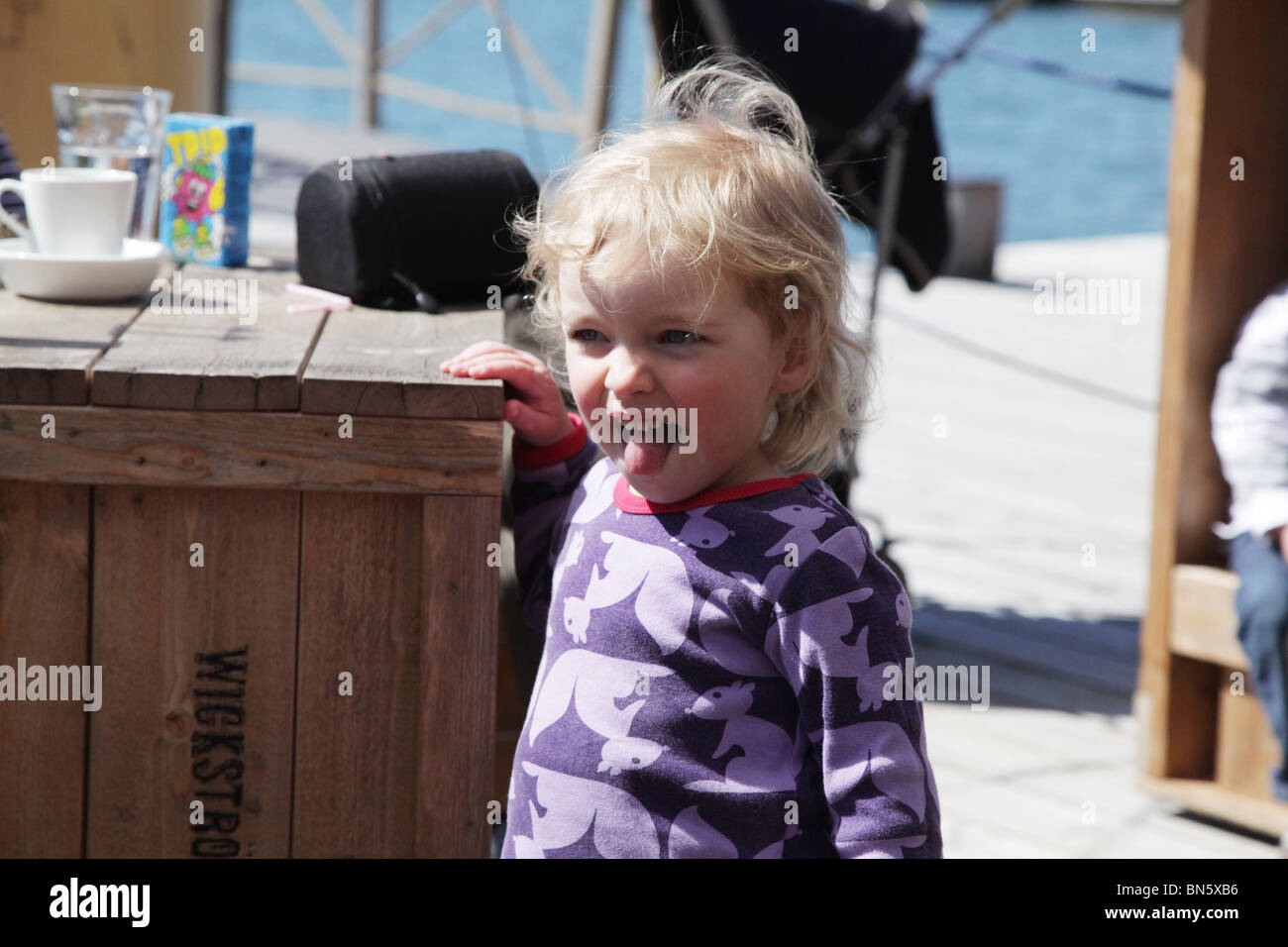 Cute toddler girl baby poke pokes out tongue with smile MODEL RELEASED ...