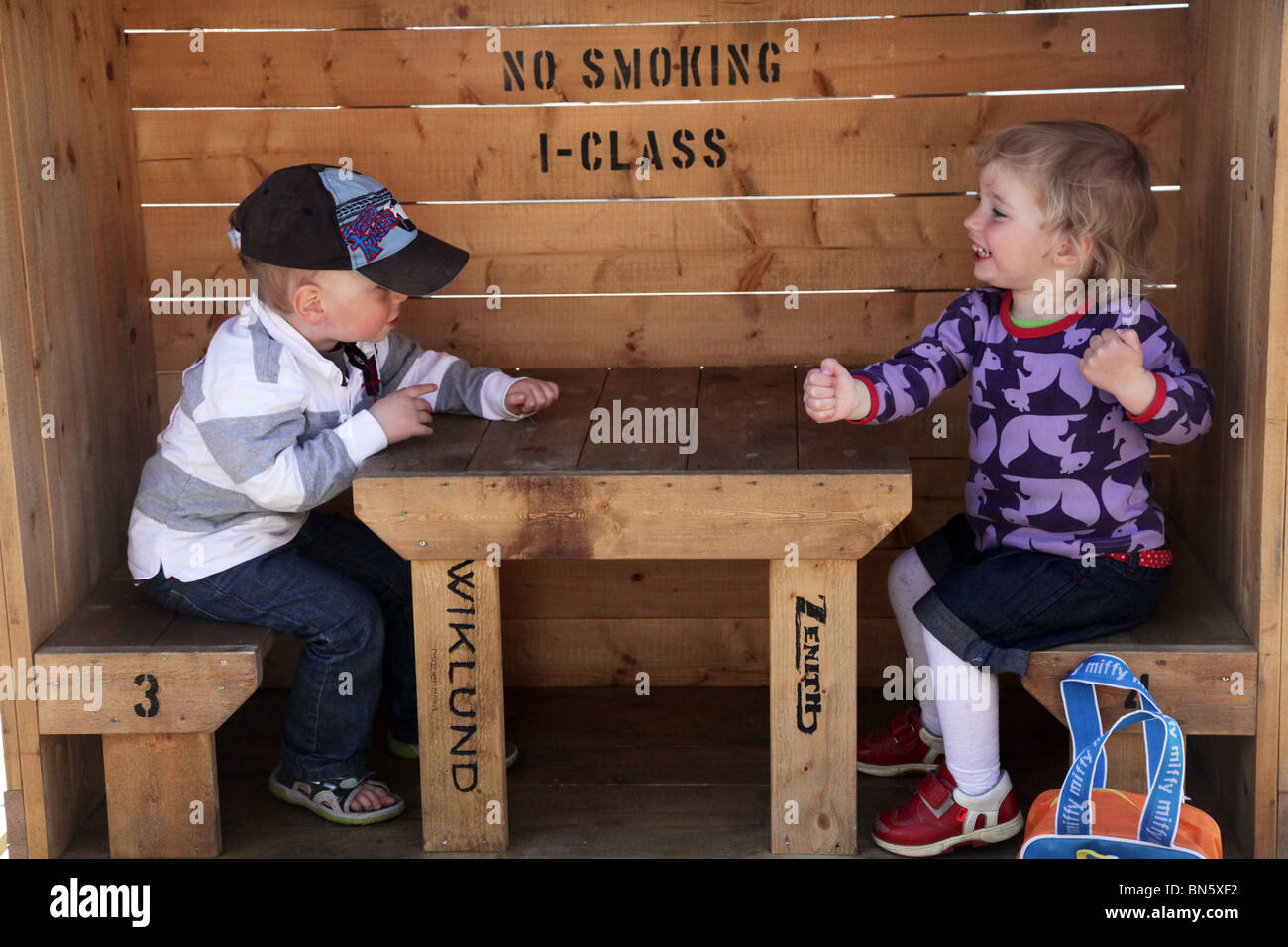 Toddlers siblings boy girl play playing fight fighting together sat ...
