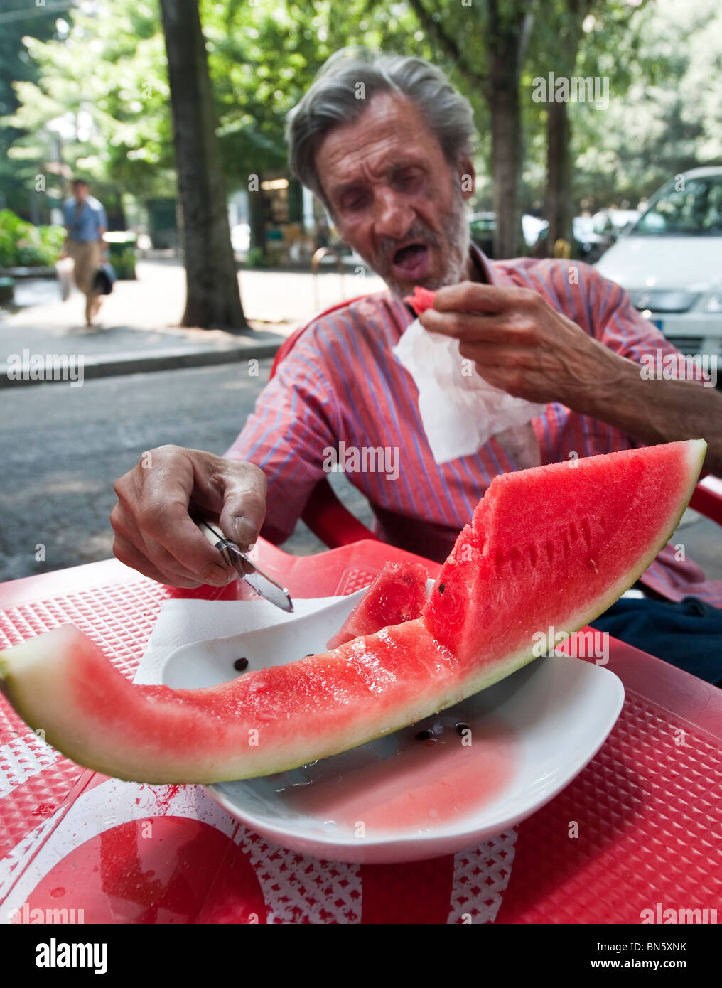 An elderly man eating a watermelon on a hot summer day Stock Photo - Alamy