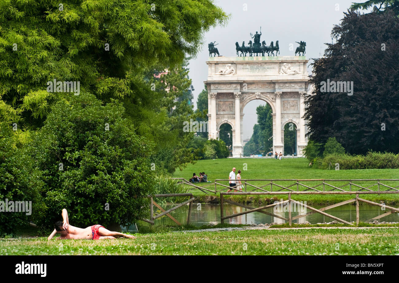 A man sunbathing in Parco Sempione Milan Italy on a hot summer day ...