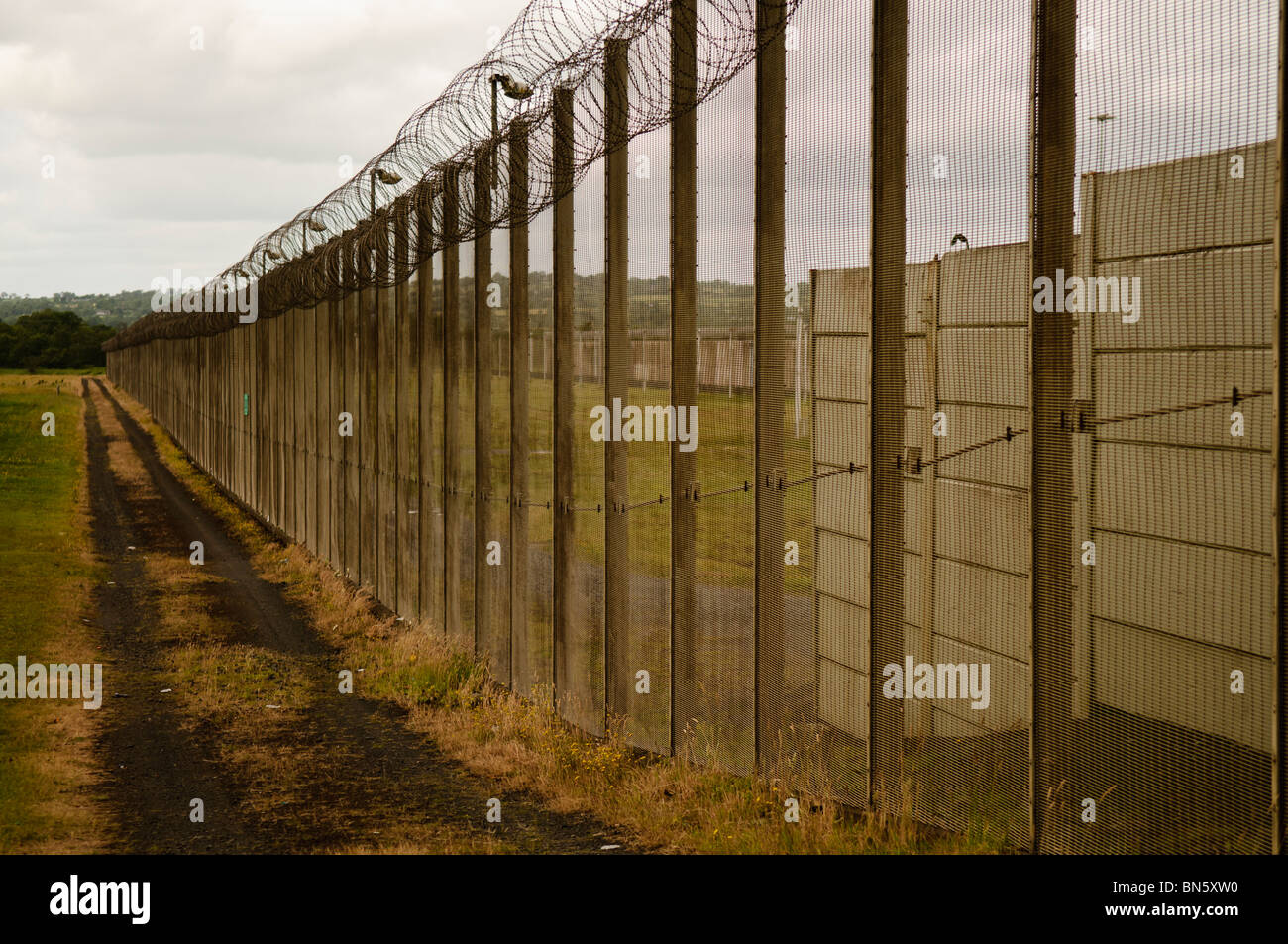 Outer fence of a high security prison topped with razor wire Stock ...