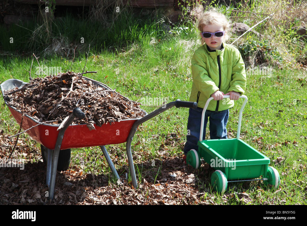 Plastic wheelbarrow toy hi-res stock photography and images - Alamy