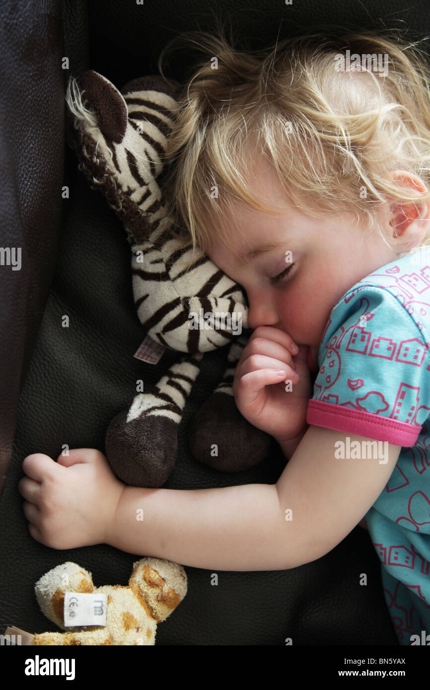 Toddler child girl sleeping taking a nap in the afternoon on a sofa ...