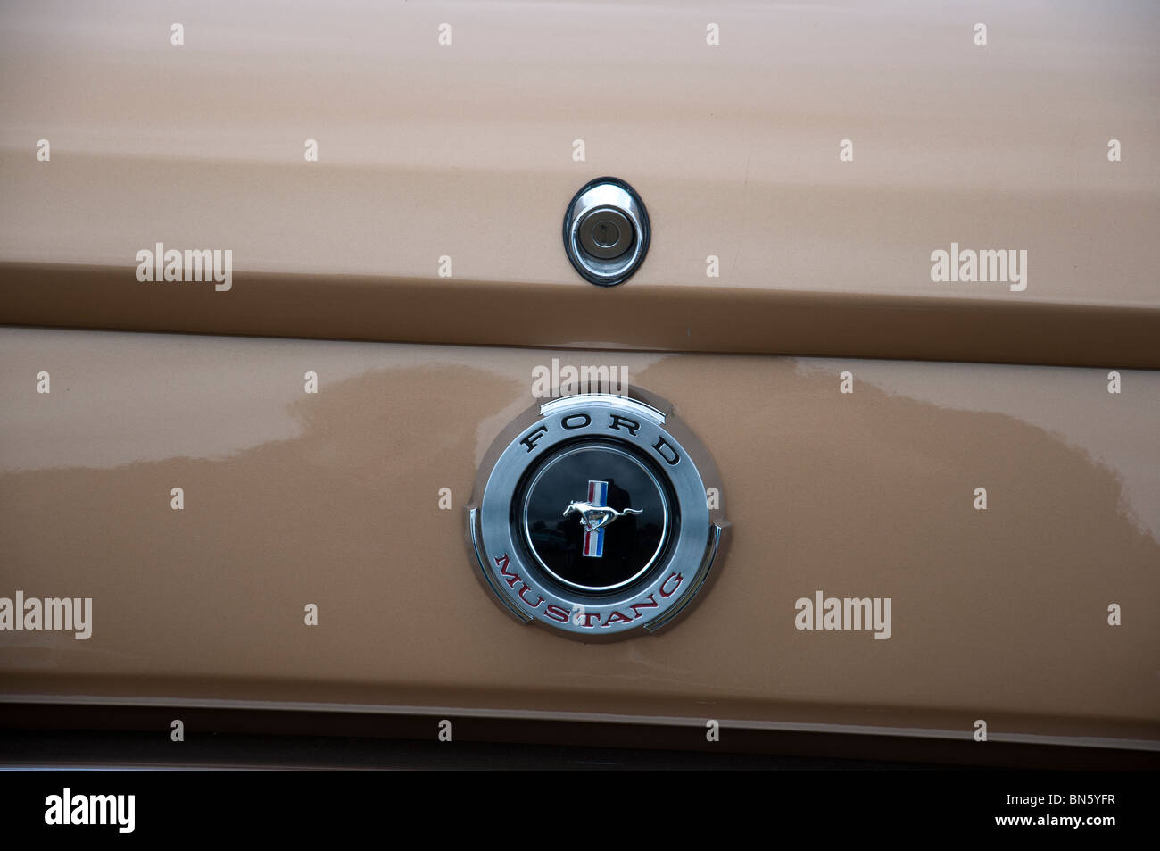 The Ford logo on a 1964 Ford Mustang car at an American car show on 4th ...