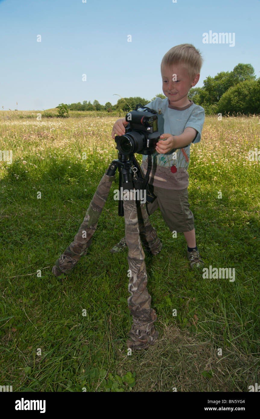 Young boy using camera Stock Photo - Alamy