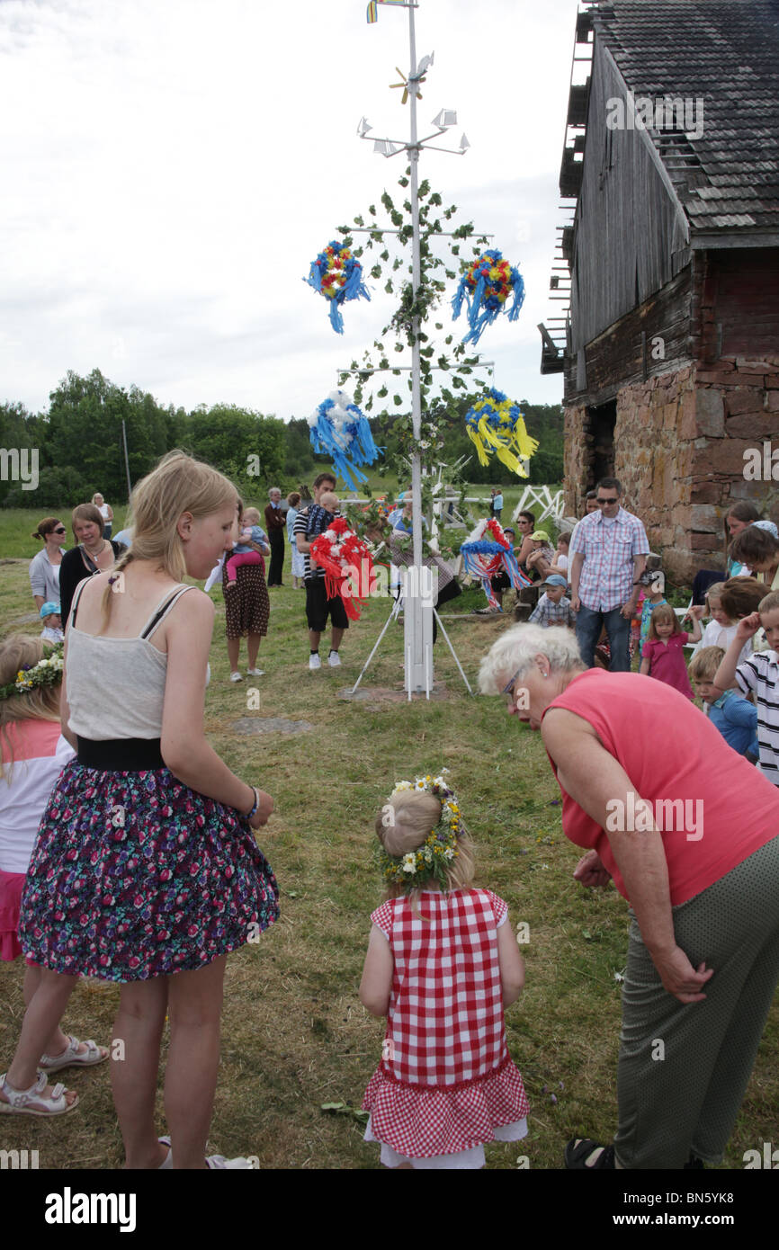 NORDIC TRADITIONAL MIDSUMMER FAMILY FAMILIES: Families dancing around the Midsummer pole on the ...