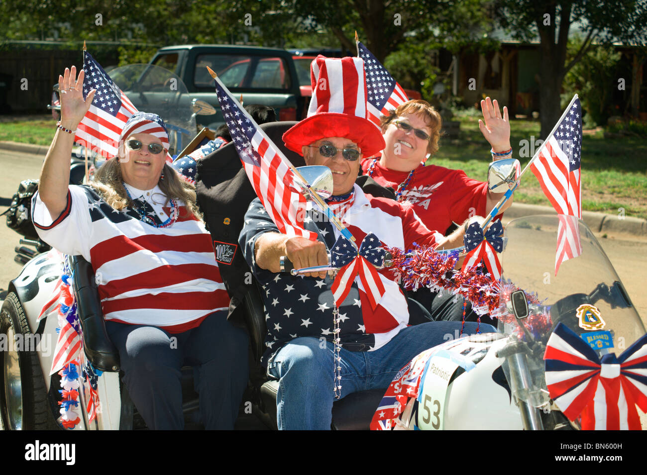 Parade participants wave at the 4th of July parade in Capitan, New ...