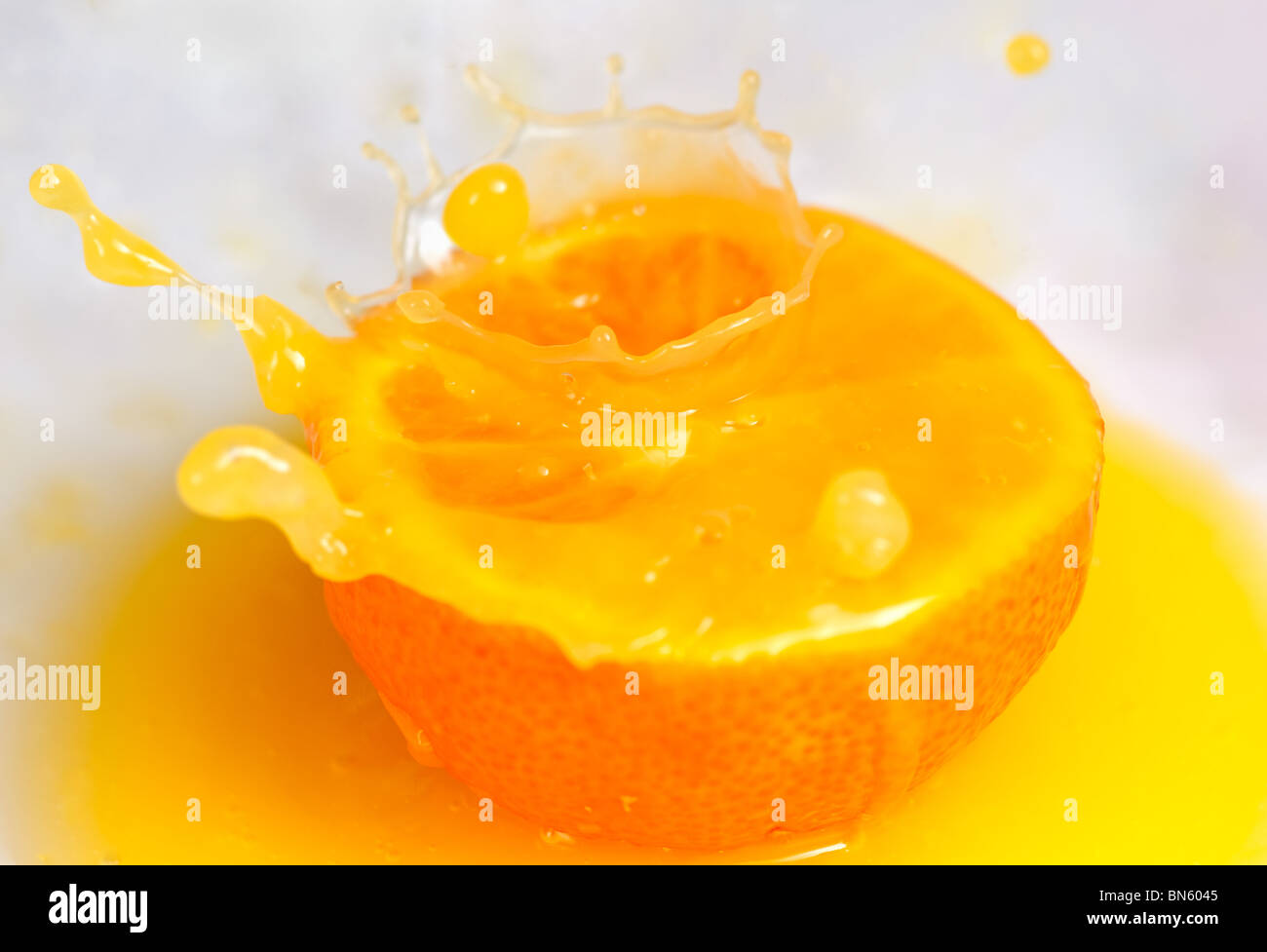 Orange splash on orange Stock Photo - Alamy