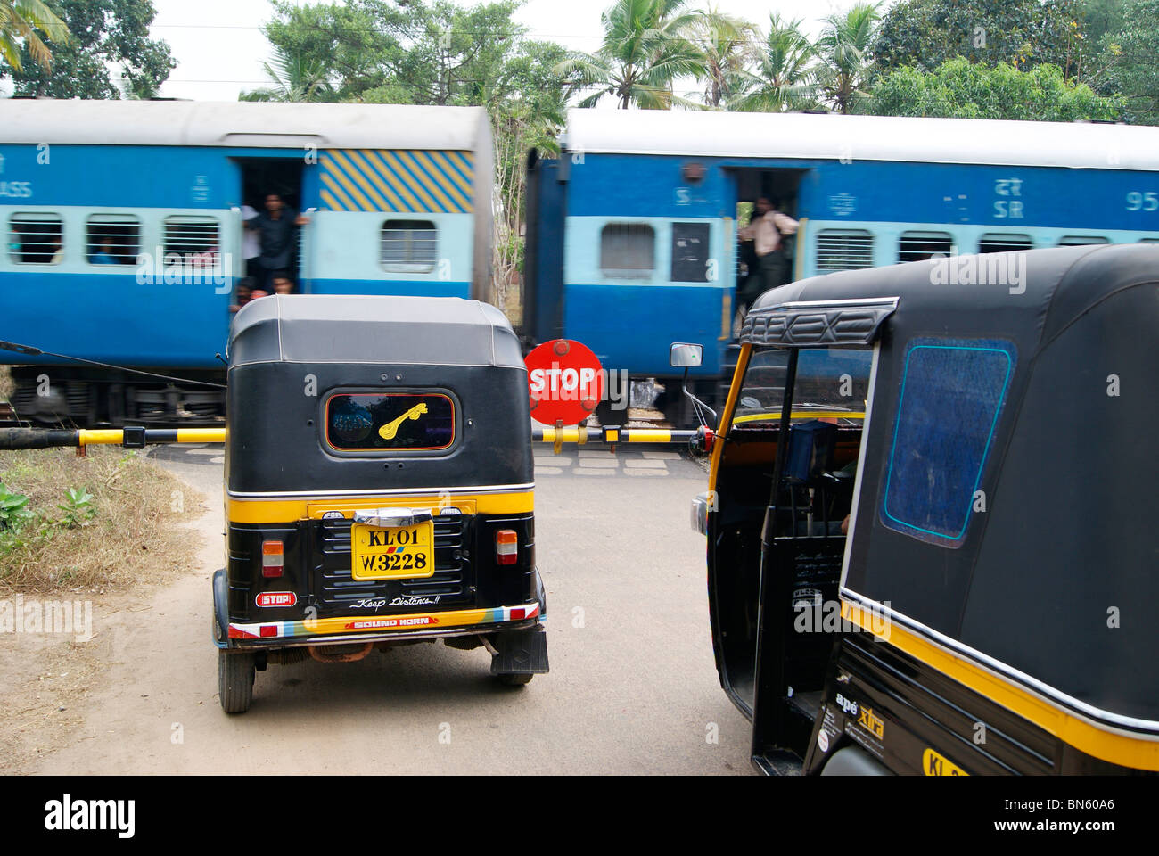Auto Rickshaw waiting in the Railway Cross.Fast Moving train in ...