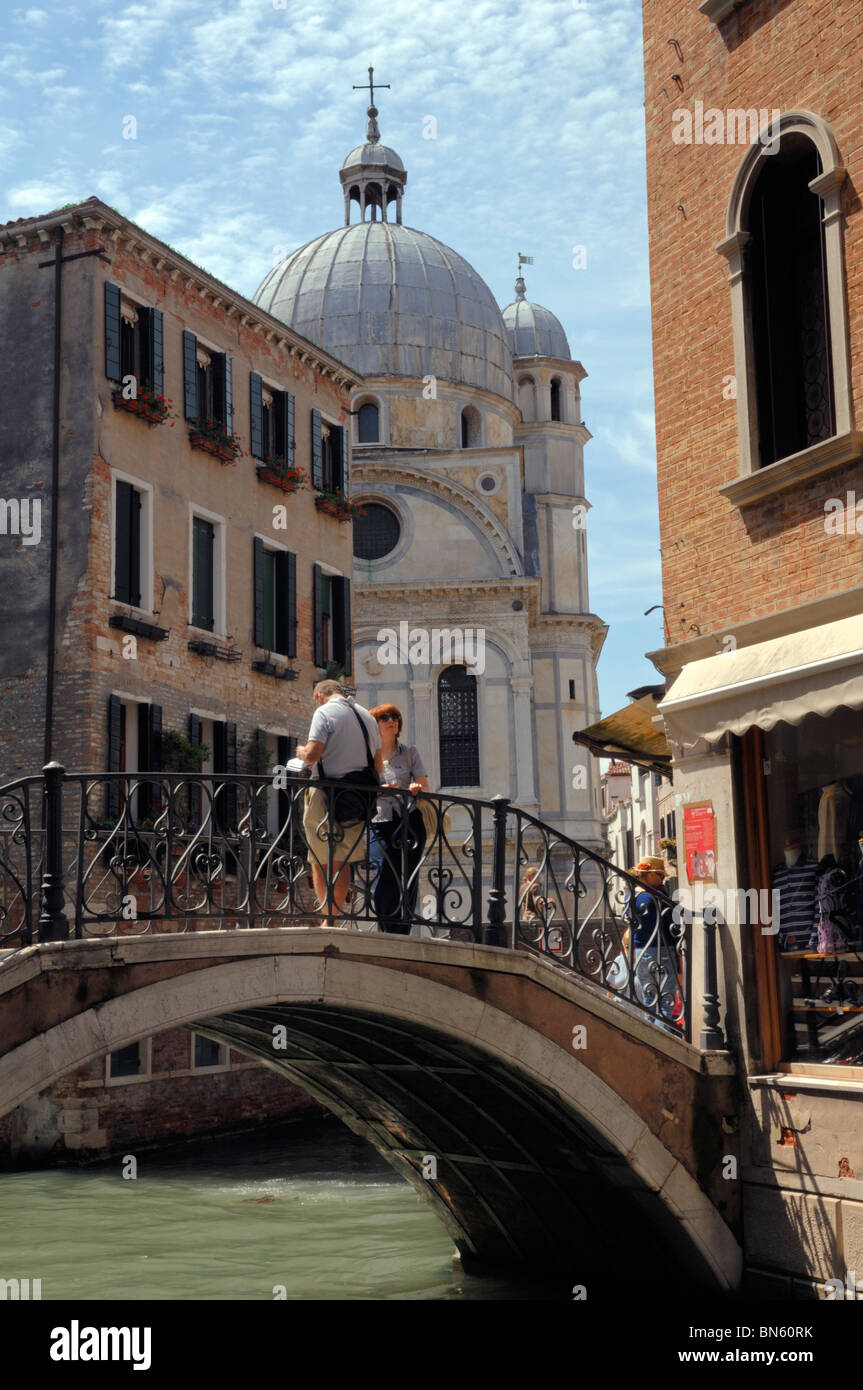 A couple consulting their guide book on a bridge near Santa Maria dei ...
