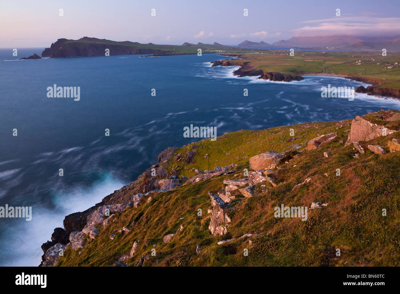 Dramatic coastal landscape illuminated at dusk, Ballyferriter Bay ...