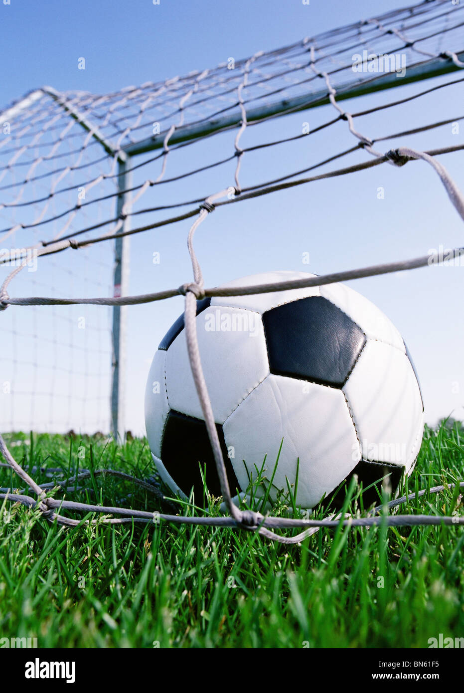 Football in the goal net Stock Photo - Alamy
