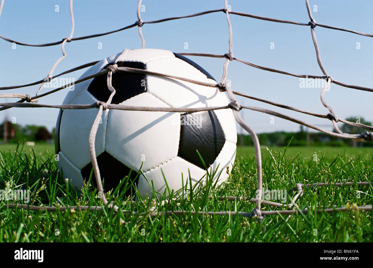 Football in the goal net Stock Photo - Alamy