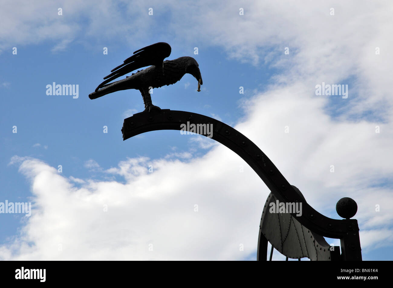 Black metal Corvinus gate with raven holding a golden ring in his beak ...