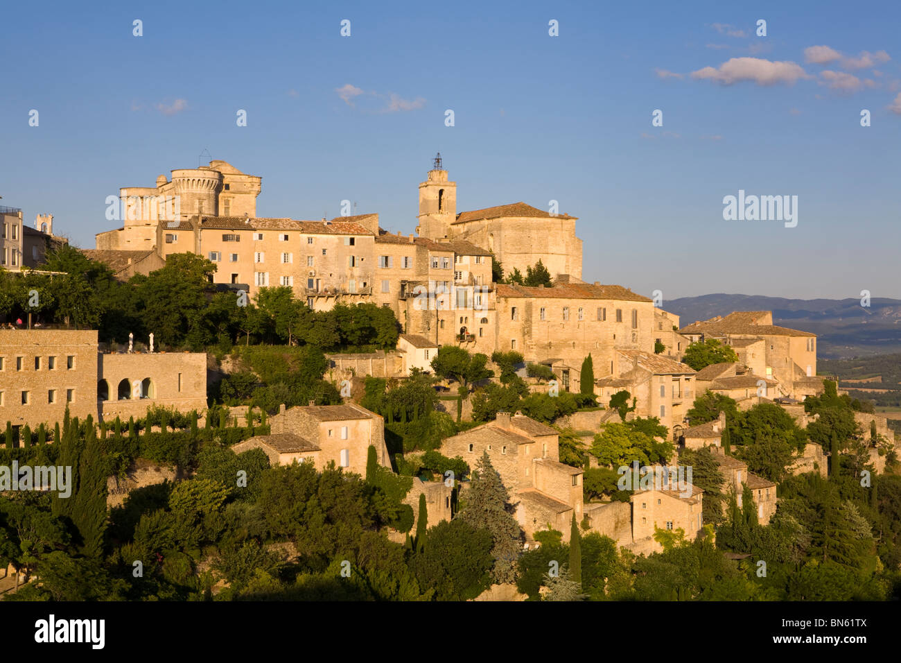 Late afternoon light illuminates the defensive hilltop village of ...