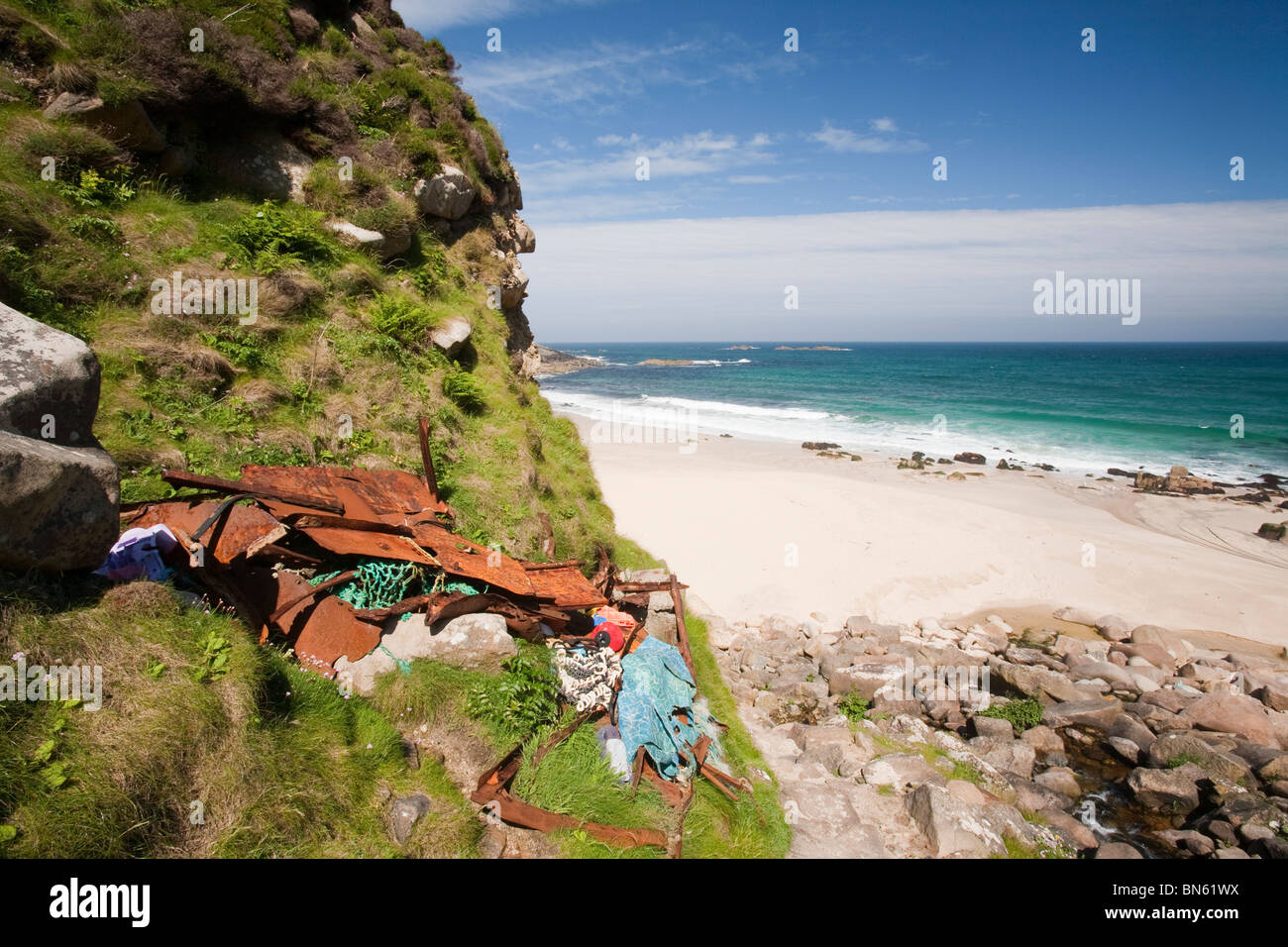 Metal from a ship wreck above the beach at Portheras Cove in Cornwall ...