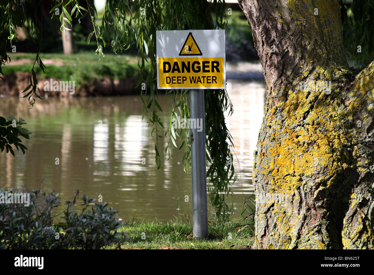 Deep water sign at caravan park fishing pond Stock Photo - Alamy