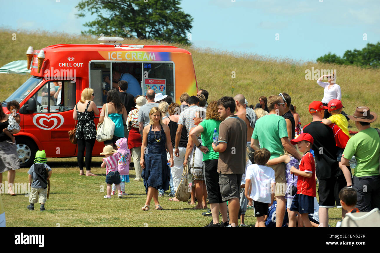 Queueing for an ice cream van in a park on a hot summers day in ...