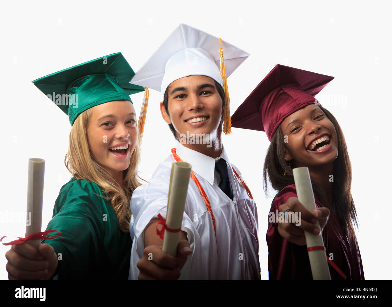 three graduates in cap and gown with diplomas Stock Photo - Alamy