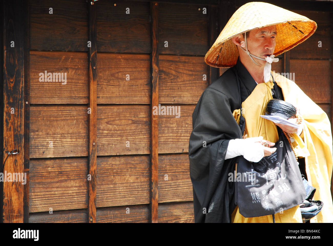 A Buddhist monk begs for alms along a street below Kiyomizu Temple in ...