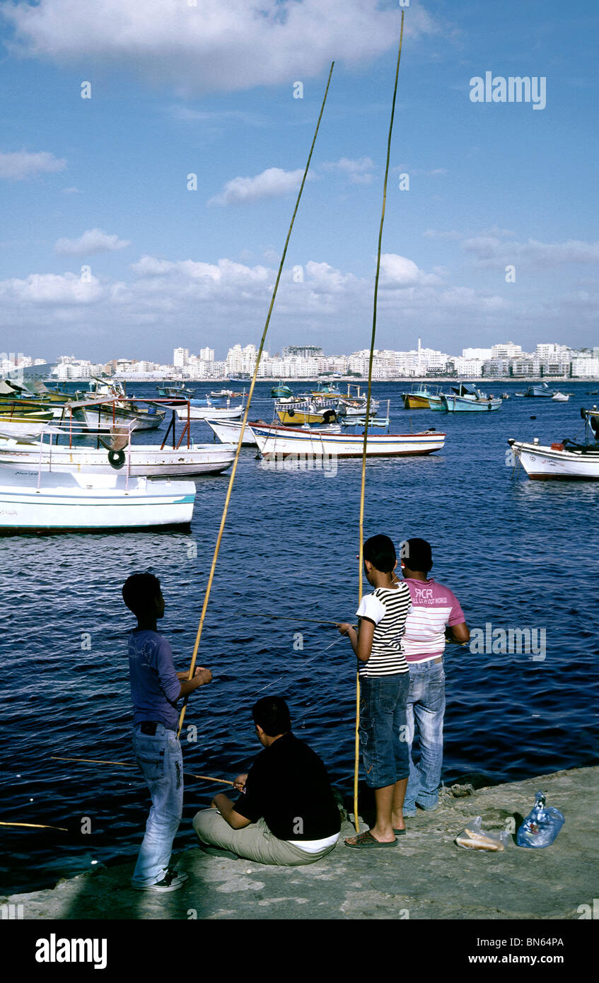 Group of boys fishing in Alexandria's Eastern Harbour Stock Photo - Alamy